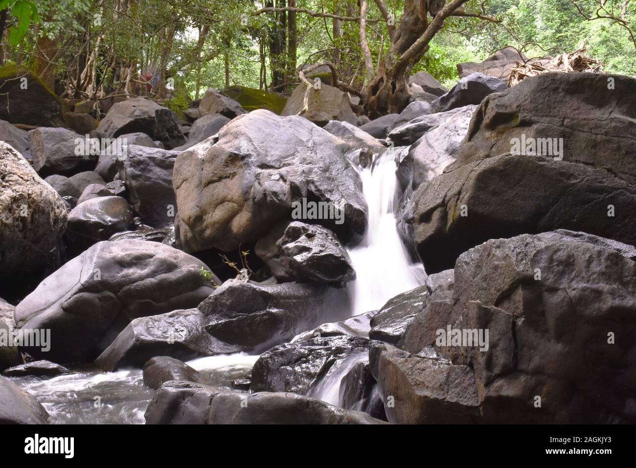 water falling through the big rocks Stock Photo - Alamy