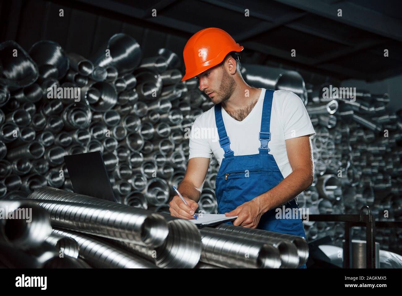 Industrial modern technology. Man in uniform works on the production ...