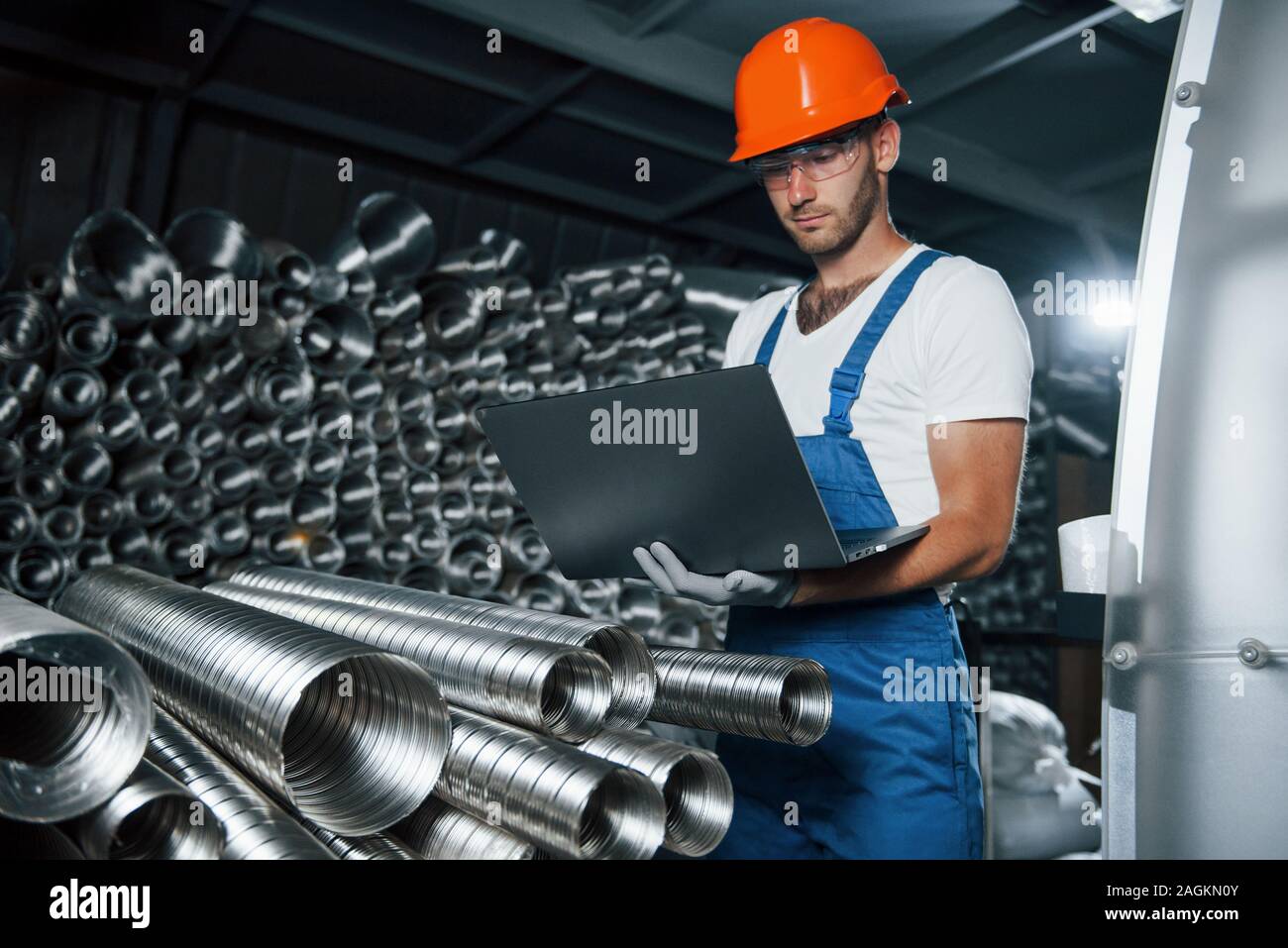 Conception of manufacturing. Man in uniform works on the production ...