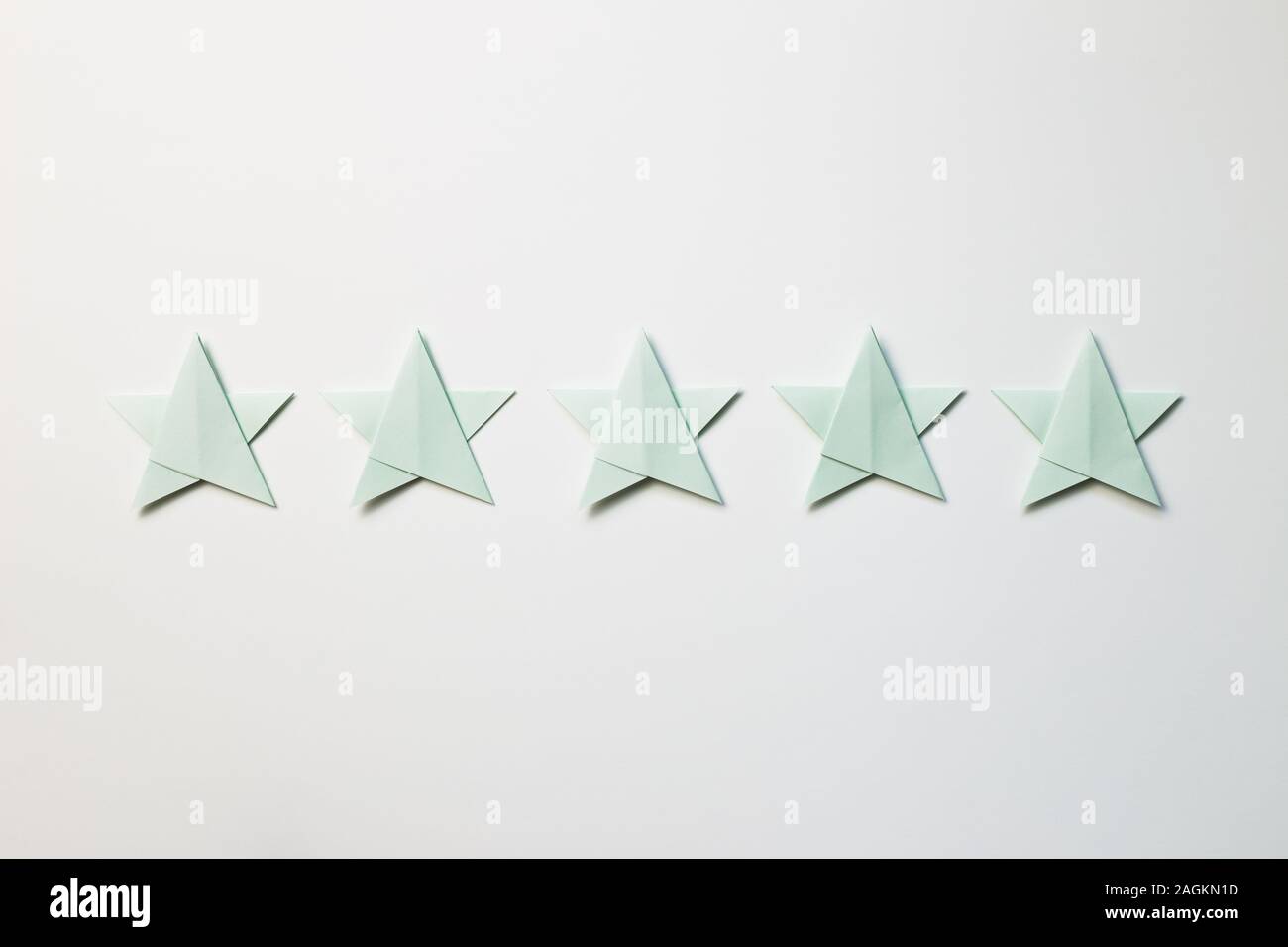 Five stars quality rating on white background Stock Photo - Alamy