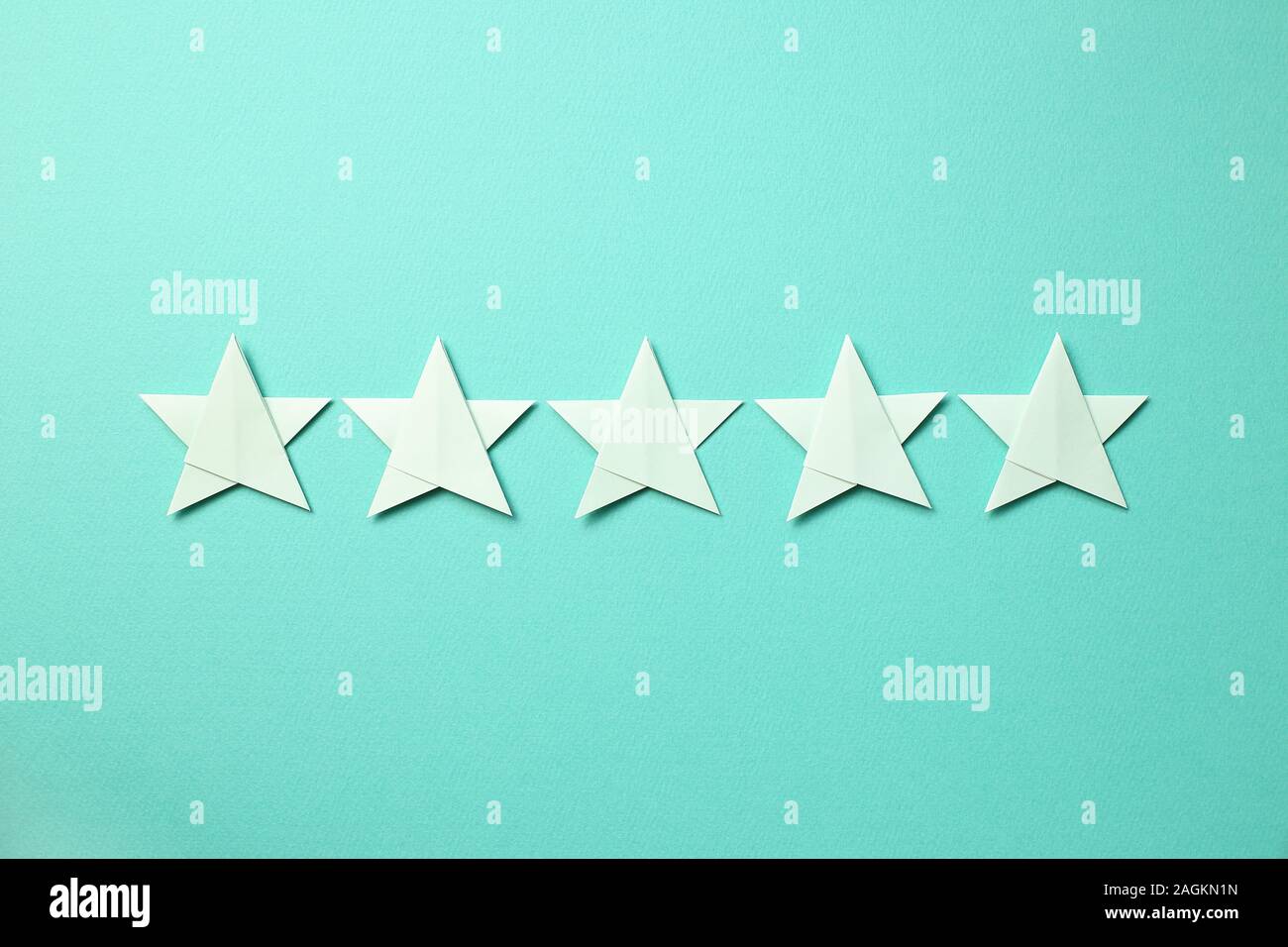 Five stars quality rating on mint green background Stock Photo - Alamy