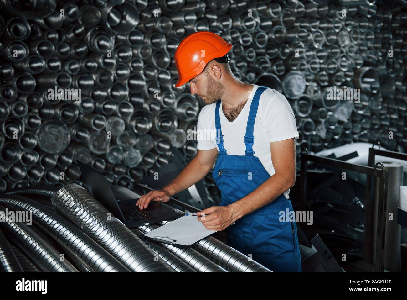 Modern manufacturing. Man in uniform works on the production ...