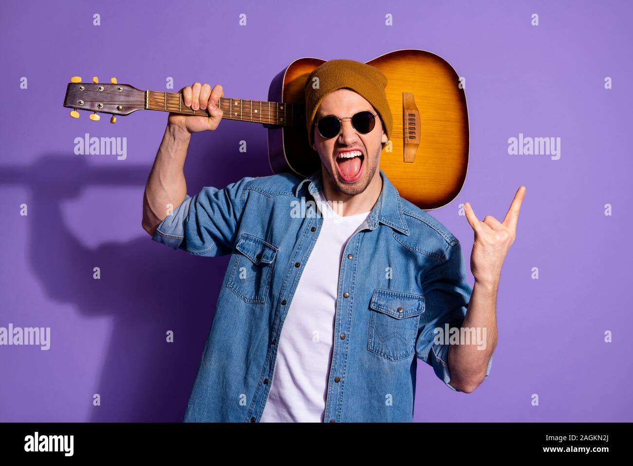 Photo of cheerful attractive rocker screaming trendy showing you rock ...