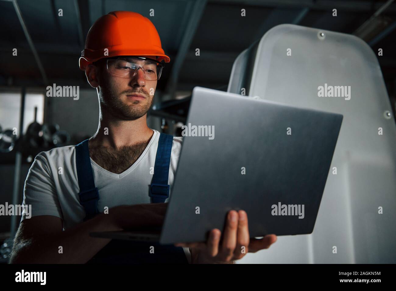 Occupation of engineer. Man in uniform works on the production ...