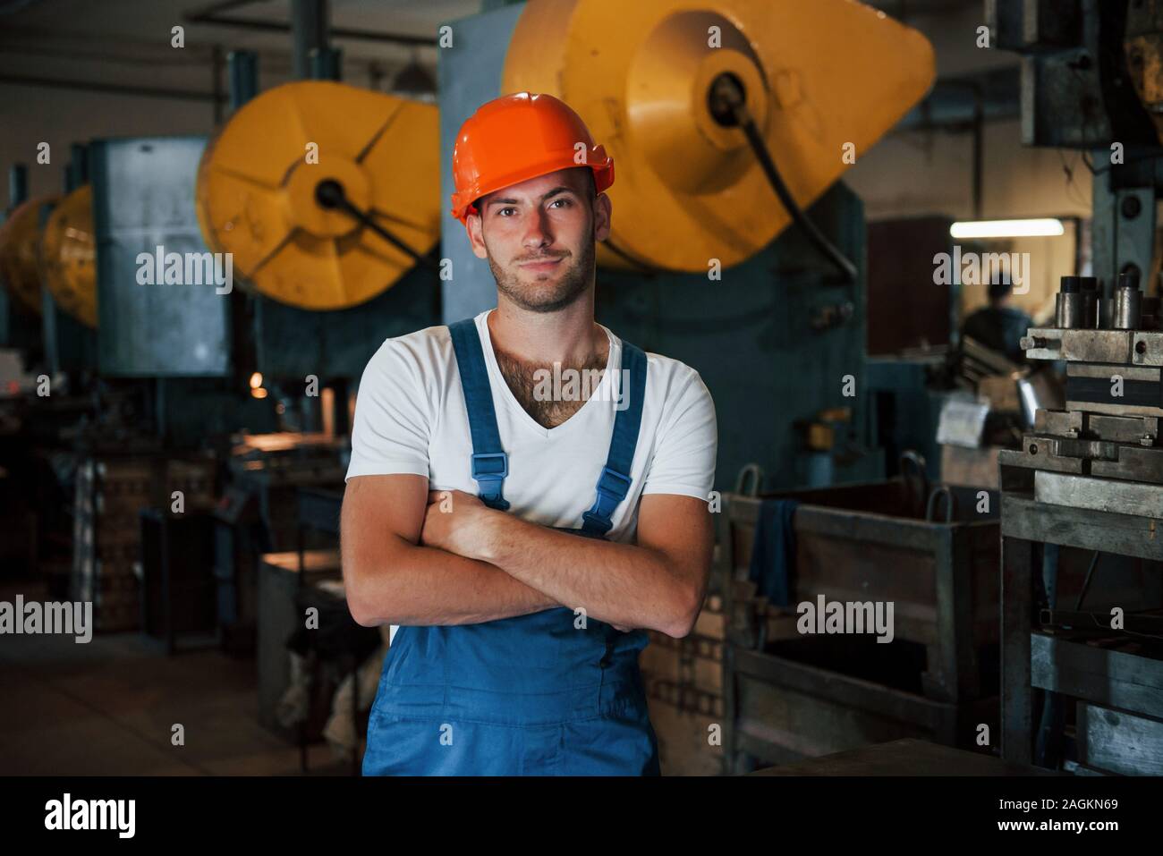 Big production machine behind. Portrait of engineer in metallurgical ...