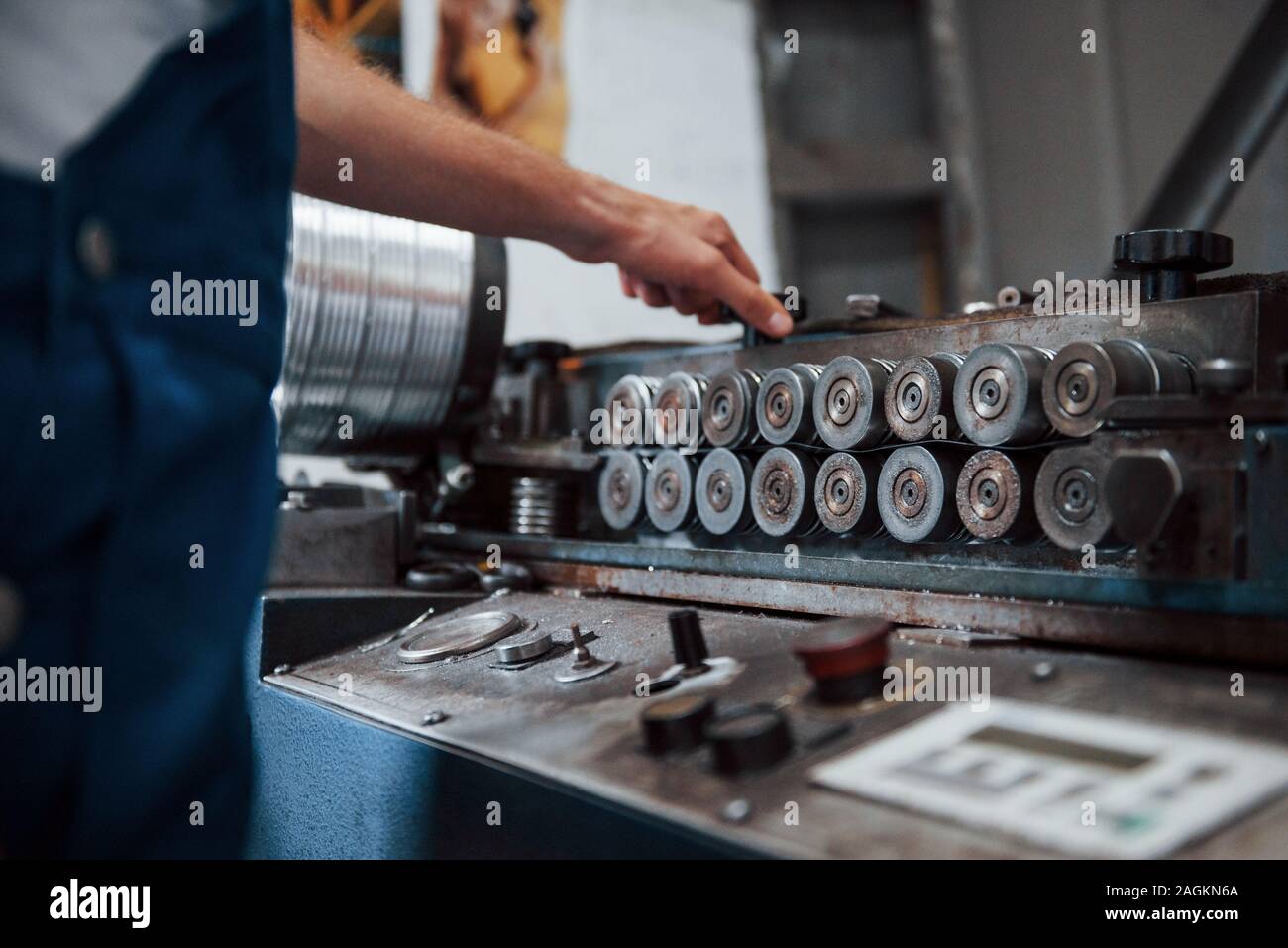 Machine operator. Man in uniform works on the production. Industrial ...