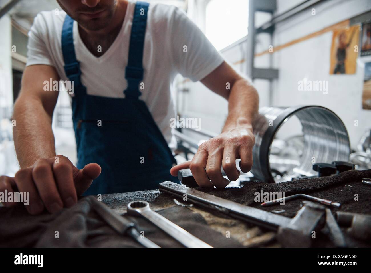 Busy guy. Man in uniform works on the production. Industrial modern ...