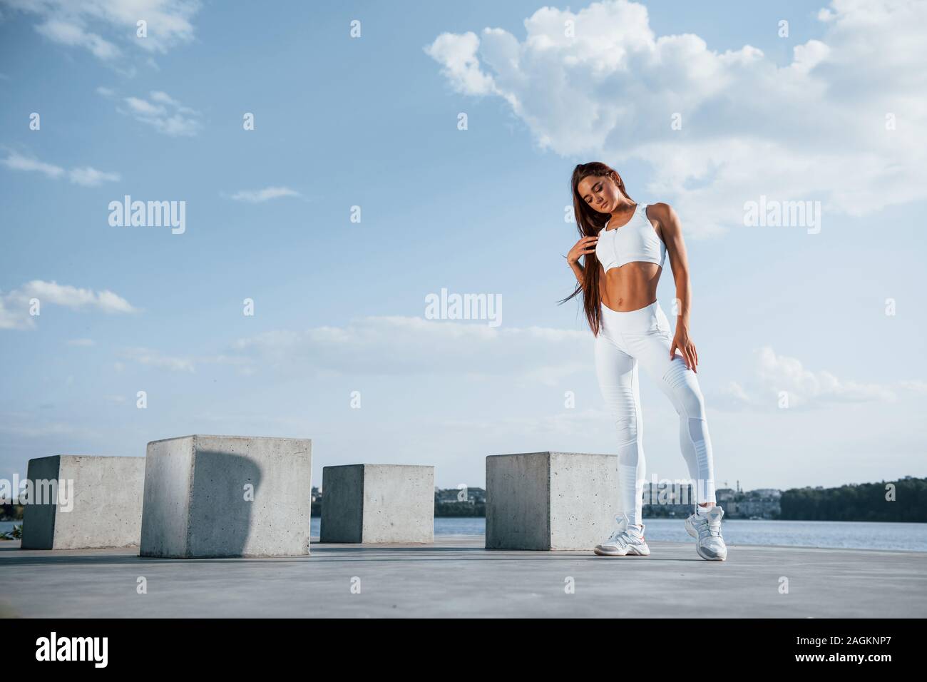 Posing for the camera. Young fitness woman with slim body type is ...