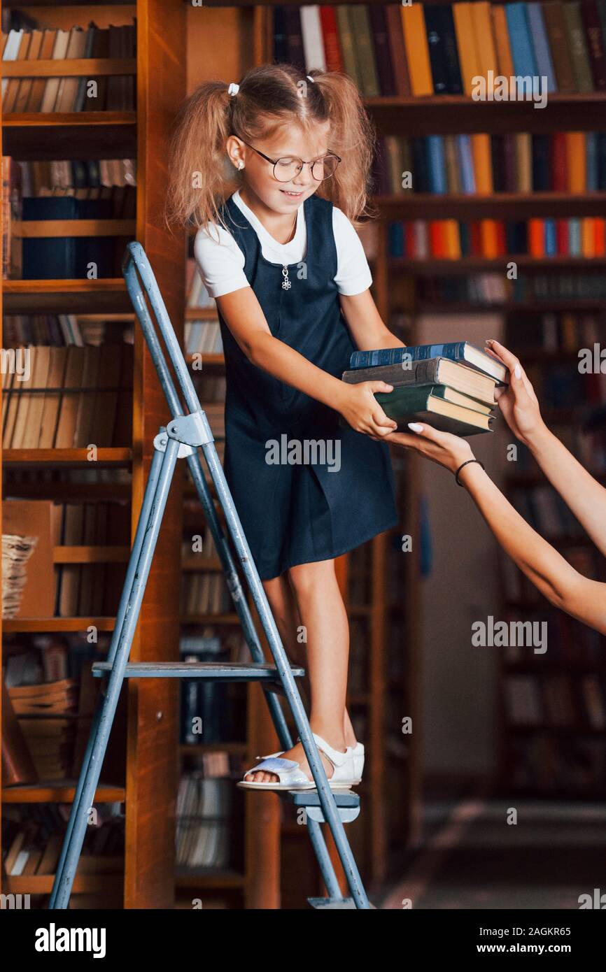 Girl on library ladder hi-res stock photography and images - Alamy