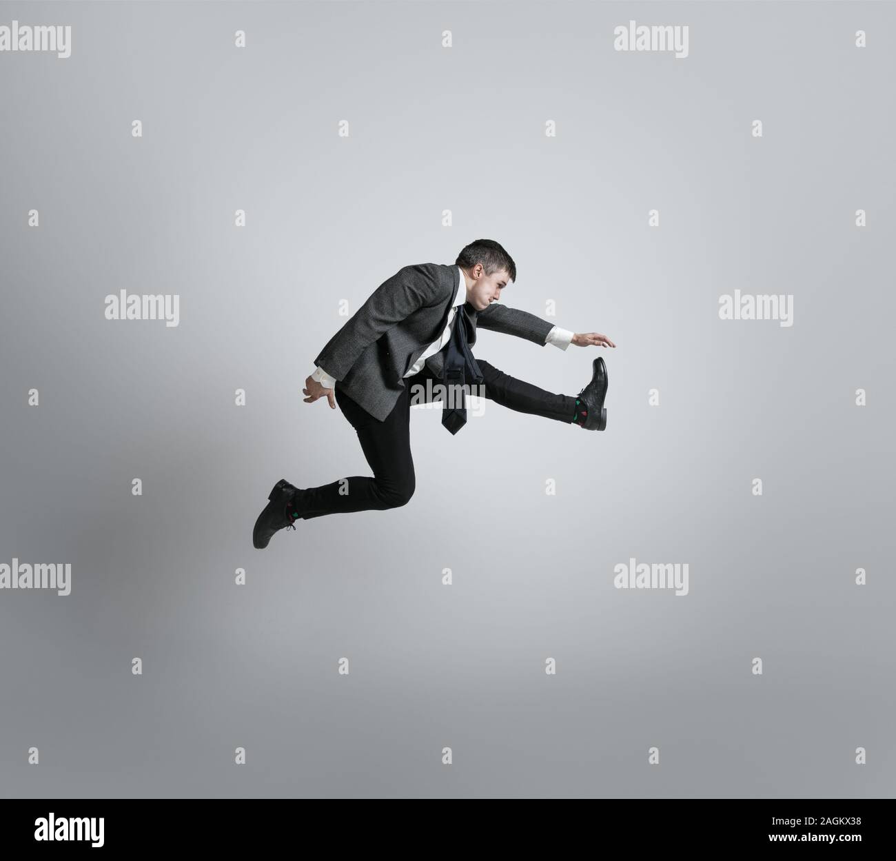 Time for movement. Man in office clothes running, jumping isolated on ...