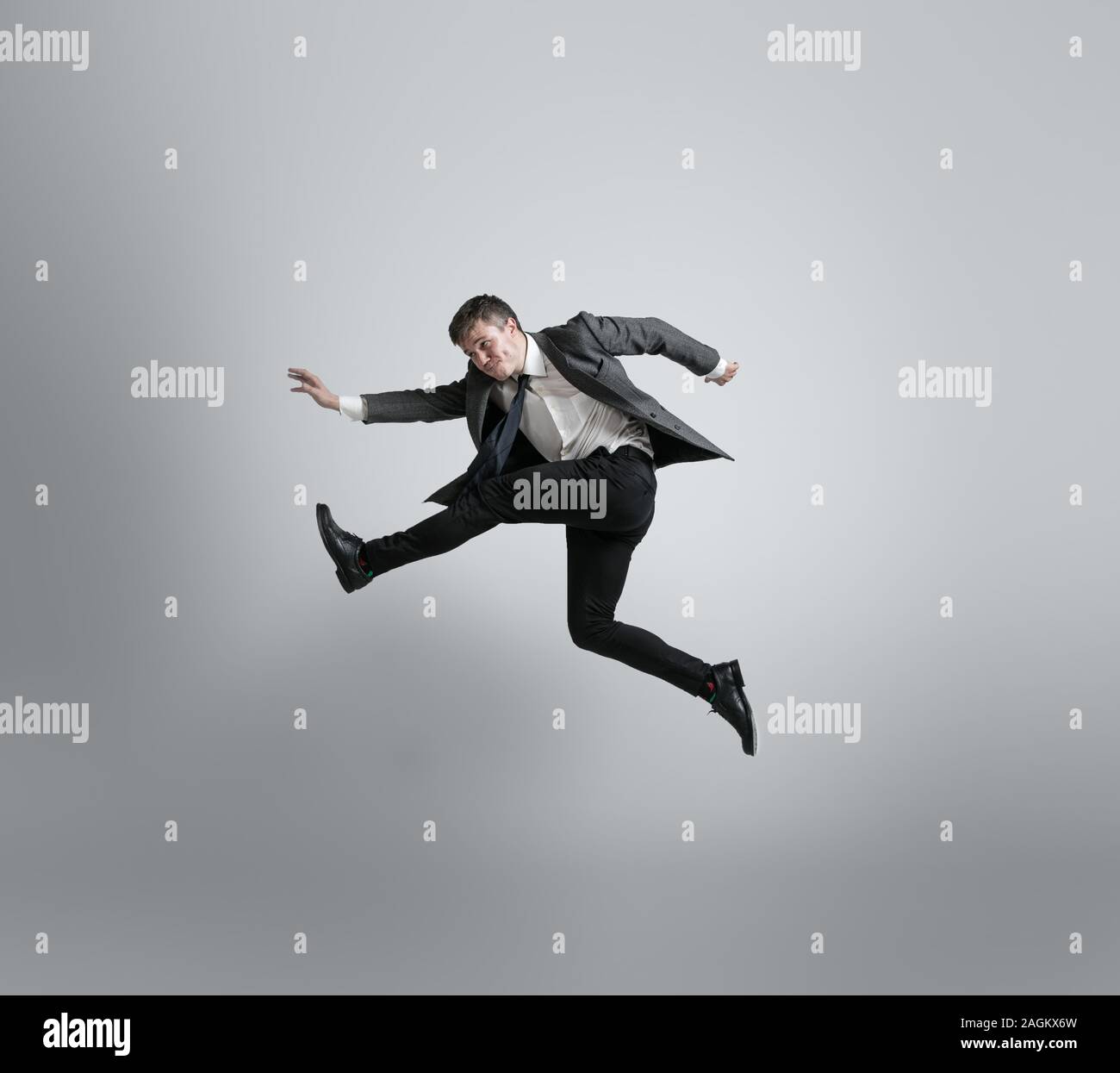 Time for movement. Man in office clothes running, jumping isolated on ...
