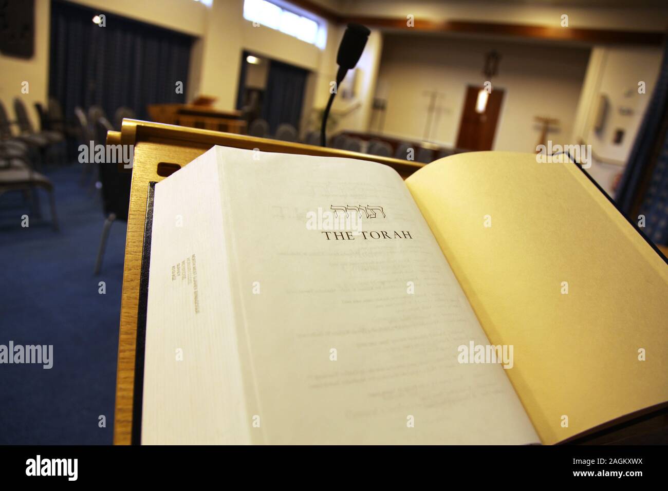 An open Torah presented on a lectern ready for a service showing title ...
