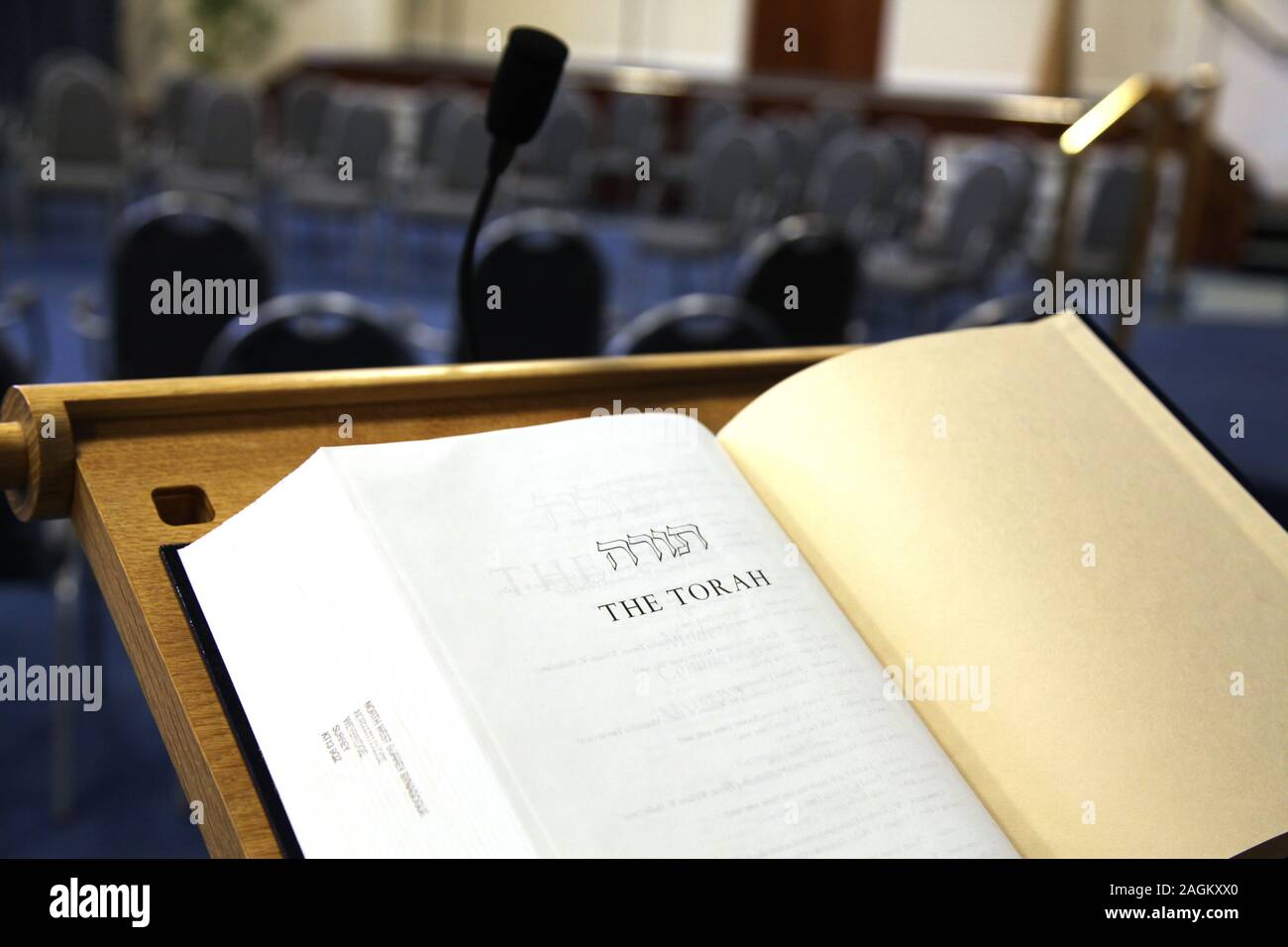 An open Torah presented on a lectern ready for a service showing title ...
