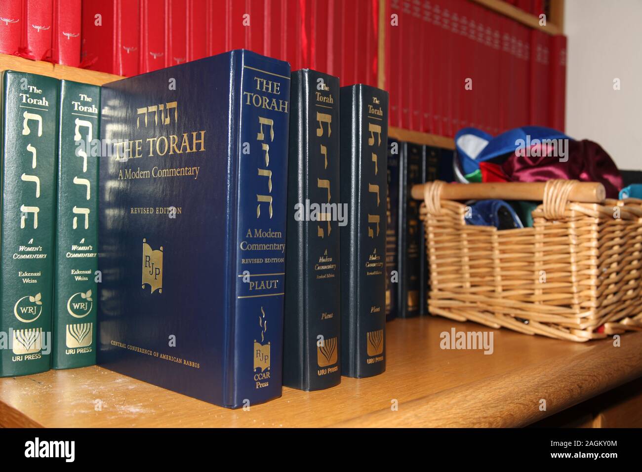 Multiple copies of the Torah stand in front of Jewish bookshelf Stock ...