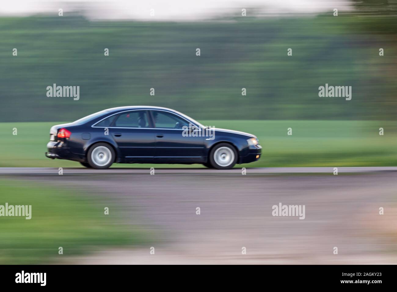 beautiful black car rides fast on the road Stock Photo - Alamy