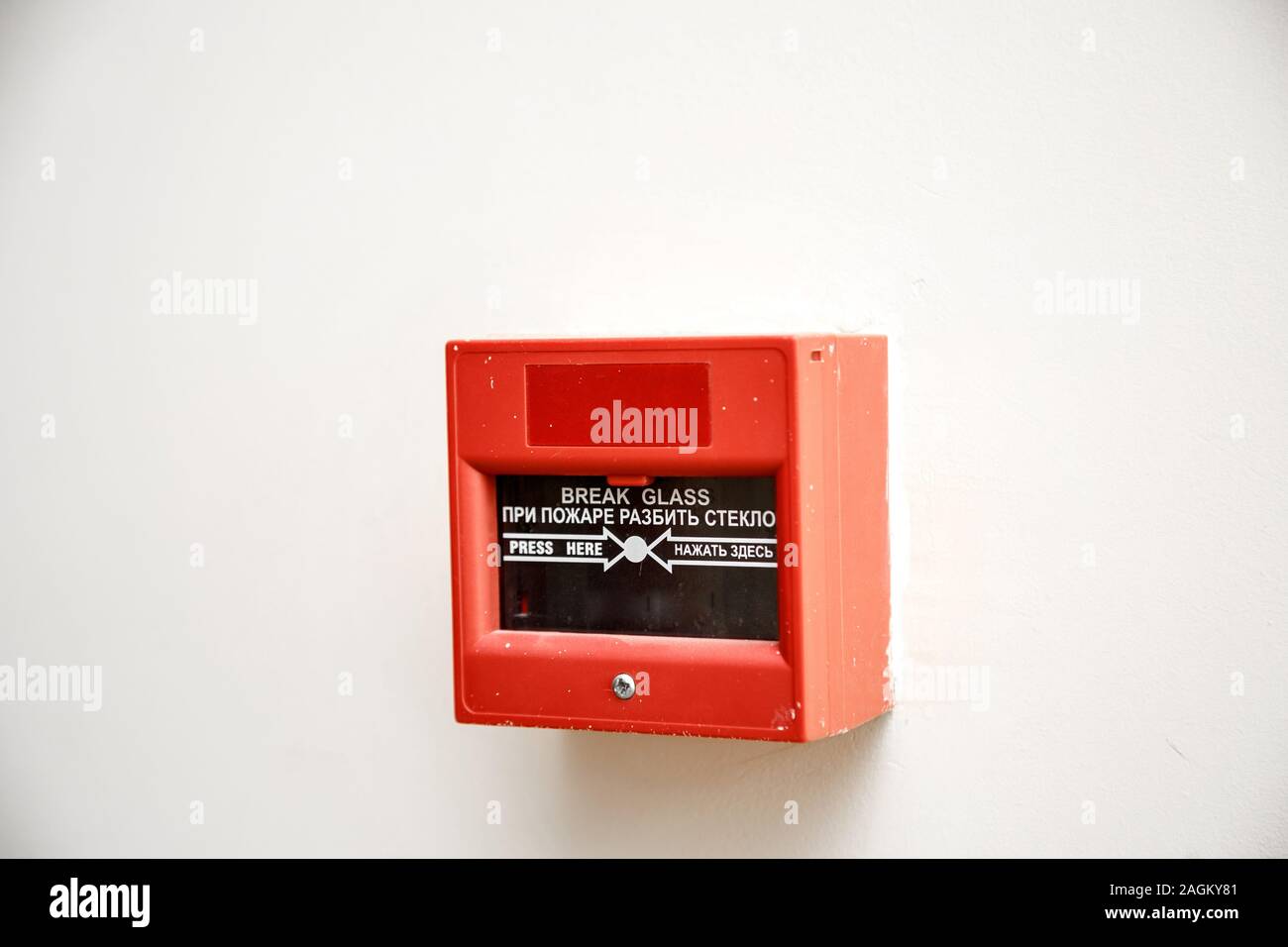 fire alarm button . with inscription in English and translation into ...