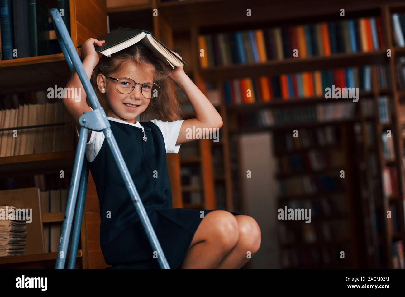 Girl on library ladder hi-res stock photography and images - Alamy