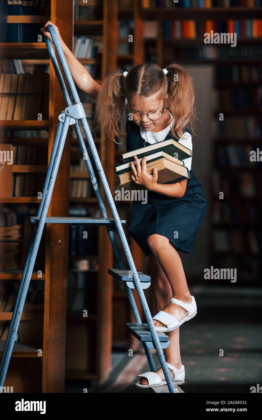 Girl on library ladder hi-res stock photography and images - Alamy