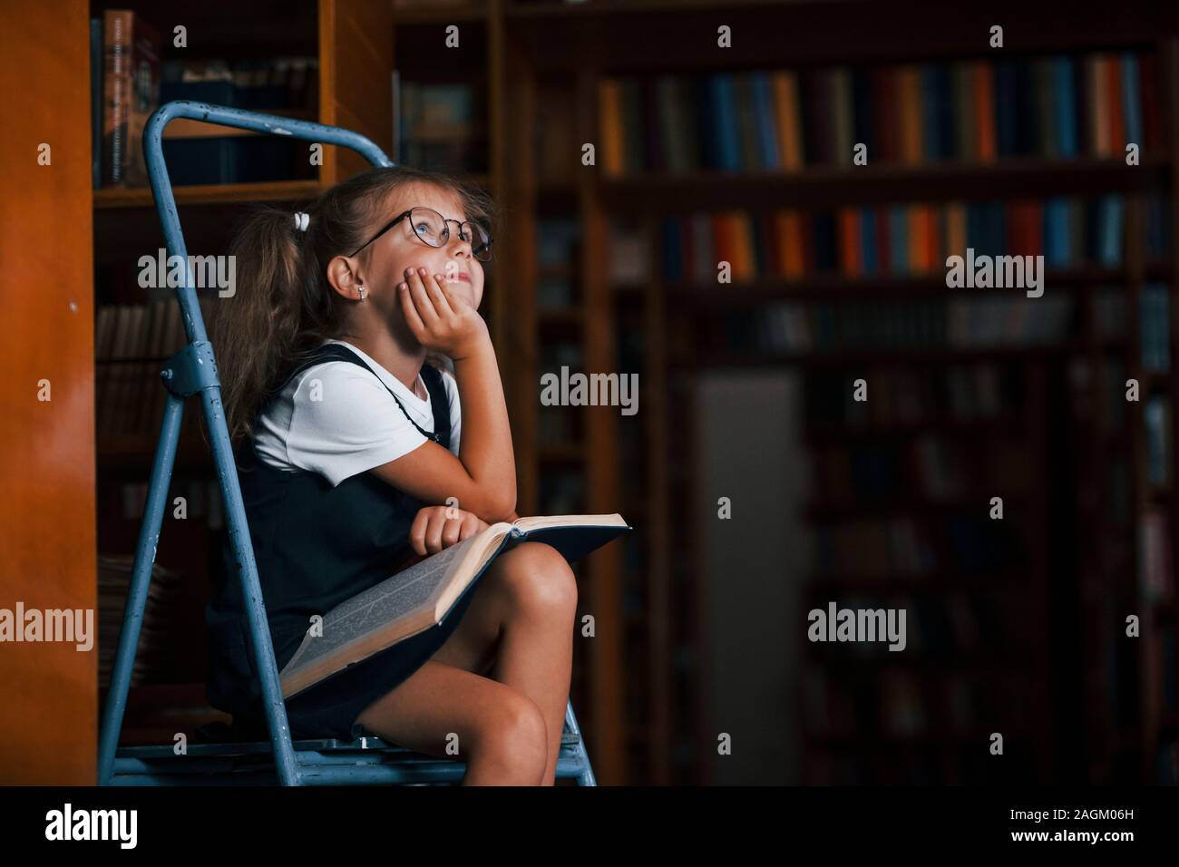 Girl on library ladder hi-res stock photography and images - Alamy