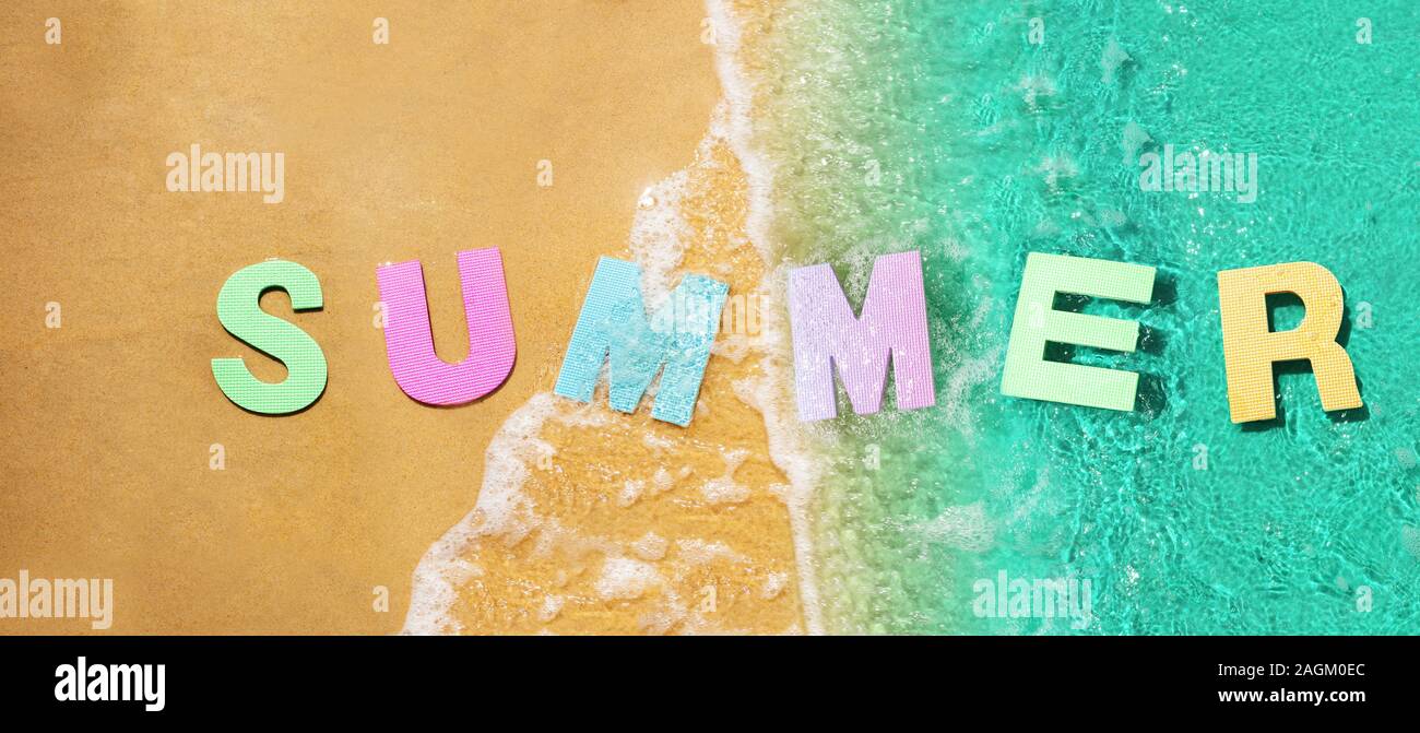 Summer sign floating in water near beach sand edge Stock Photo - Alamy
