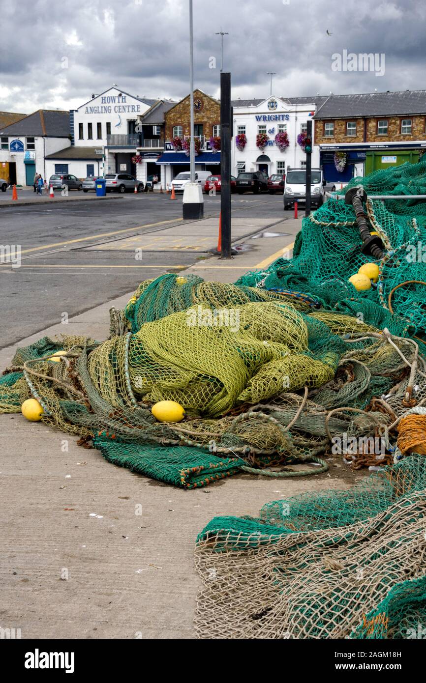 Fishing nets and view of the town of Howth, a fishing village of Dublin ...
