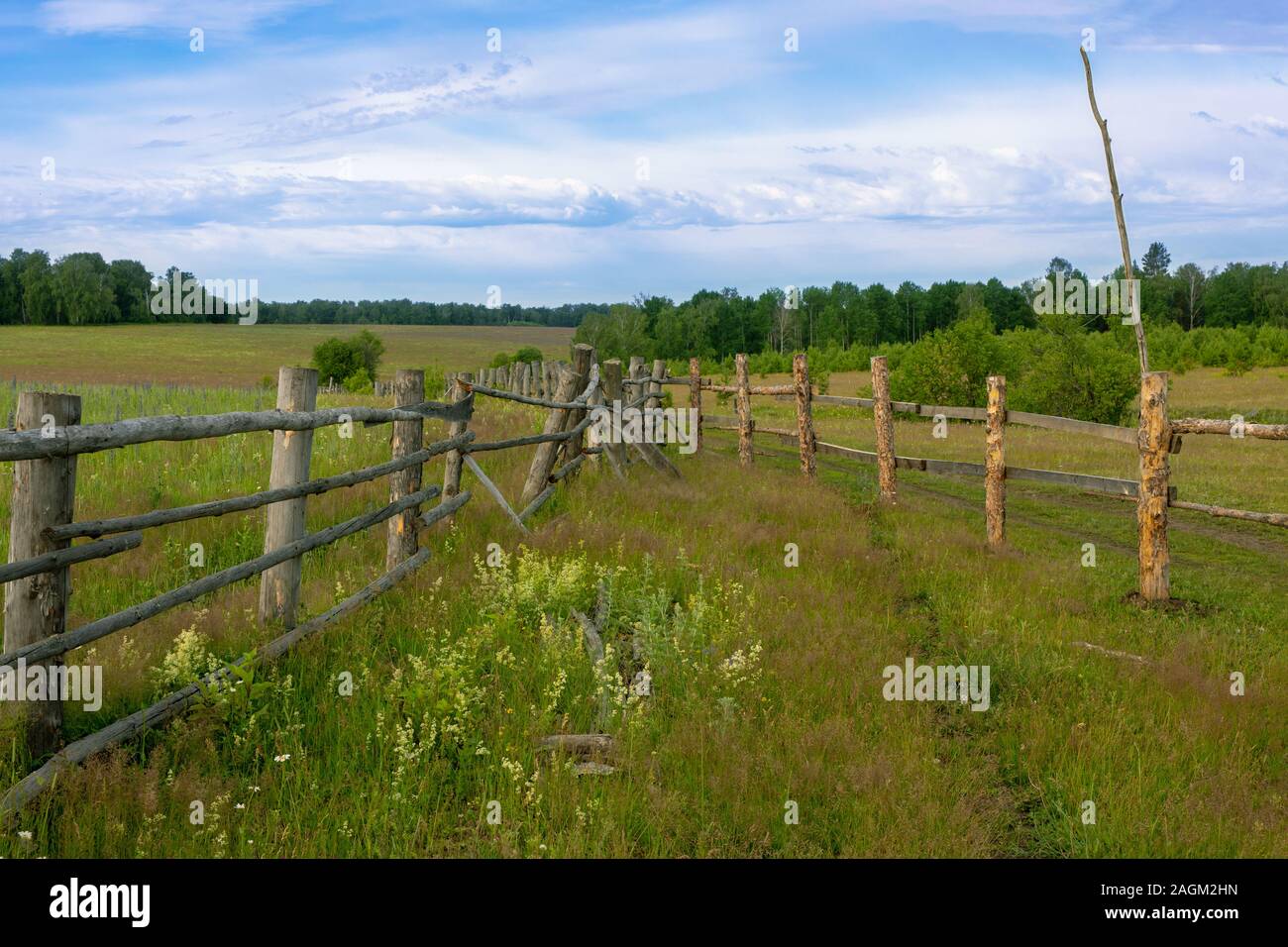 open space. wooden fences and green country field behind it. territory ...