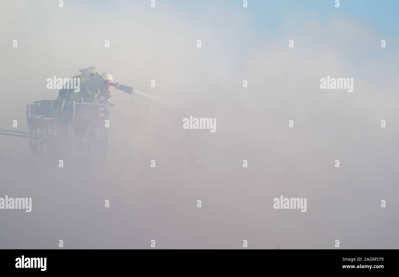 Zwenkau, Germany. 20th Dec, 2019. Firefighters extinguish a major fire ...