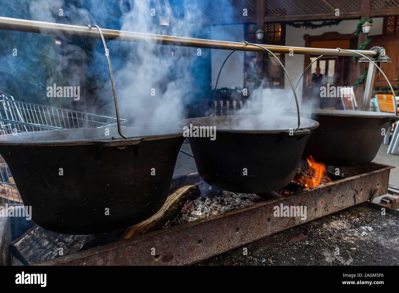Traditional cooking in a pot over campfire Stock Photo - Alamy