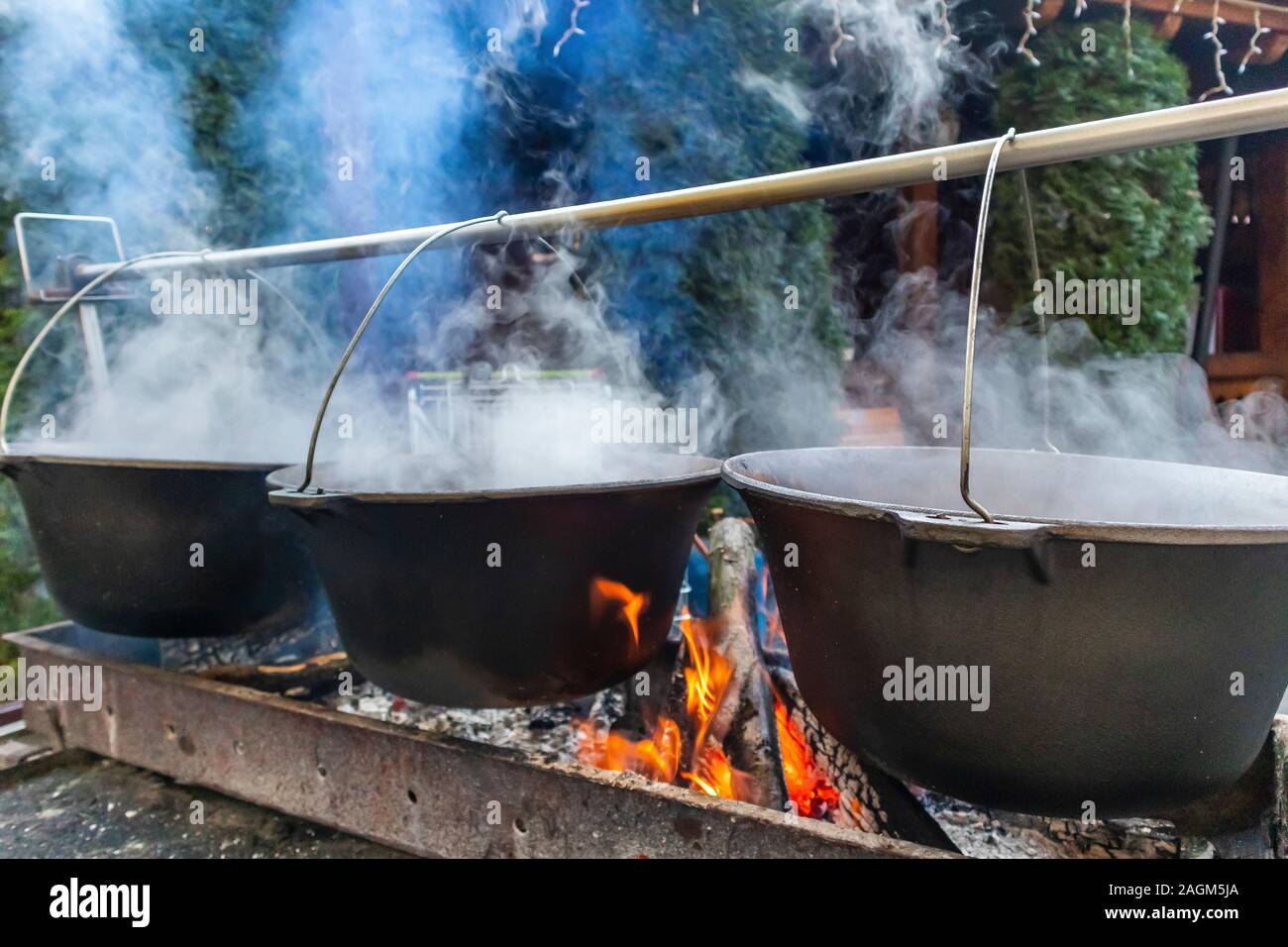 Traditional cooking in a pot over campfire Stock Photo - Alamy
