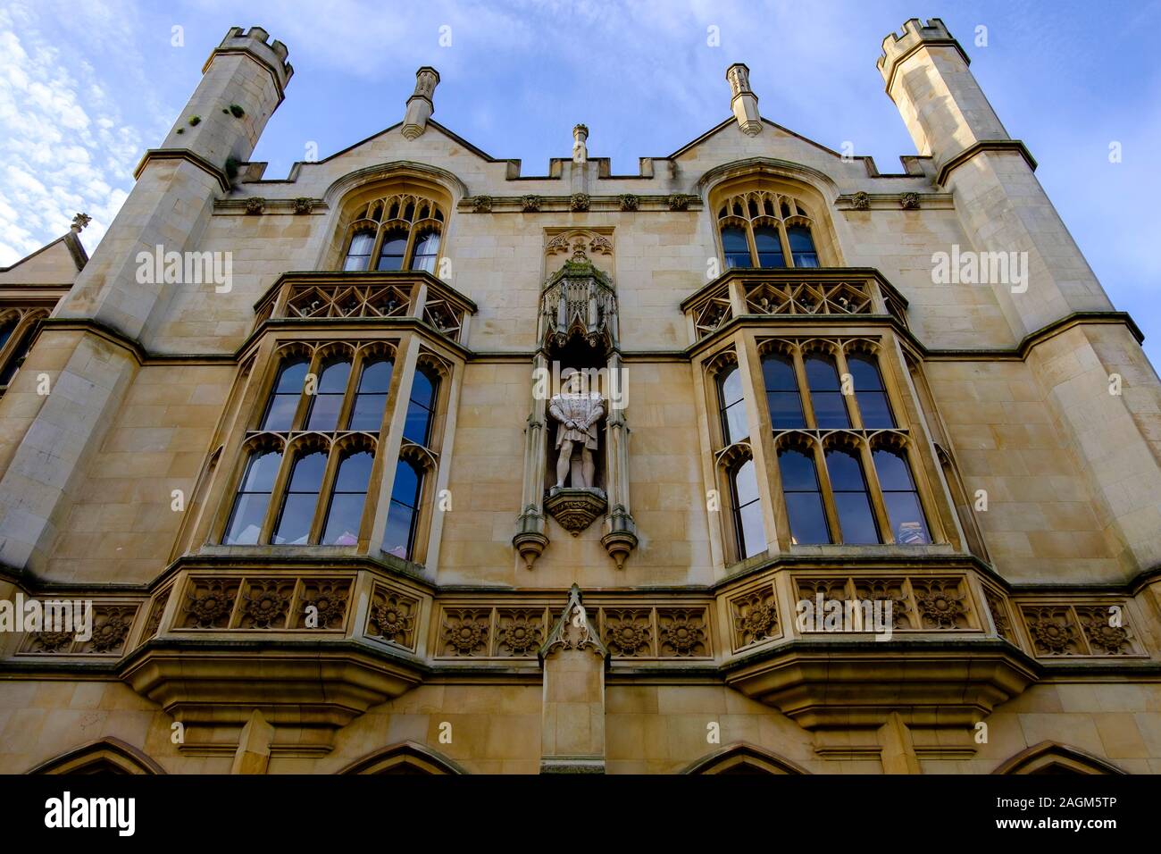 A life-size statue of Henry VIII in a short tunic and hose with a hat ...
