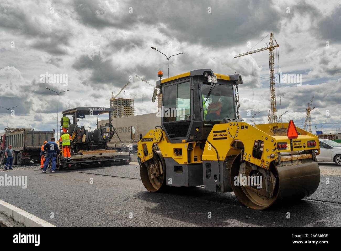 Asphalt road paver and road roller. Tyumen. Russia Stock Photo - Alamy