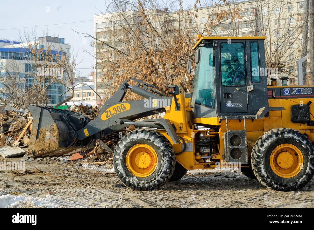 Tractor removes debris from building demolition Stock Photo - Alamy