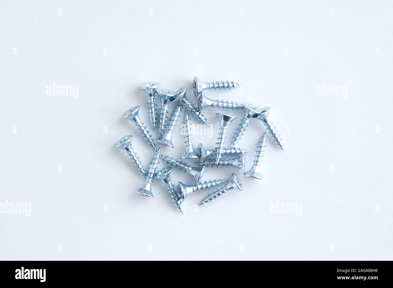 Chrome metal screws close-up. White background Stock Photo - Alamy