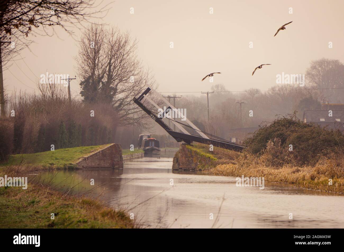 Swing bridge open to allow narrowboat through on the canal Stock Photo ...