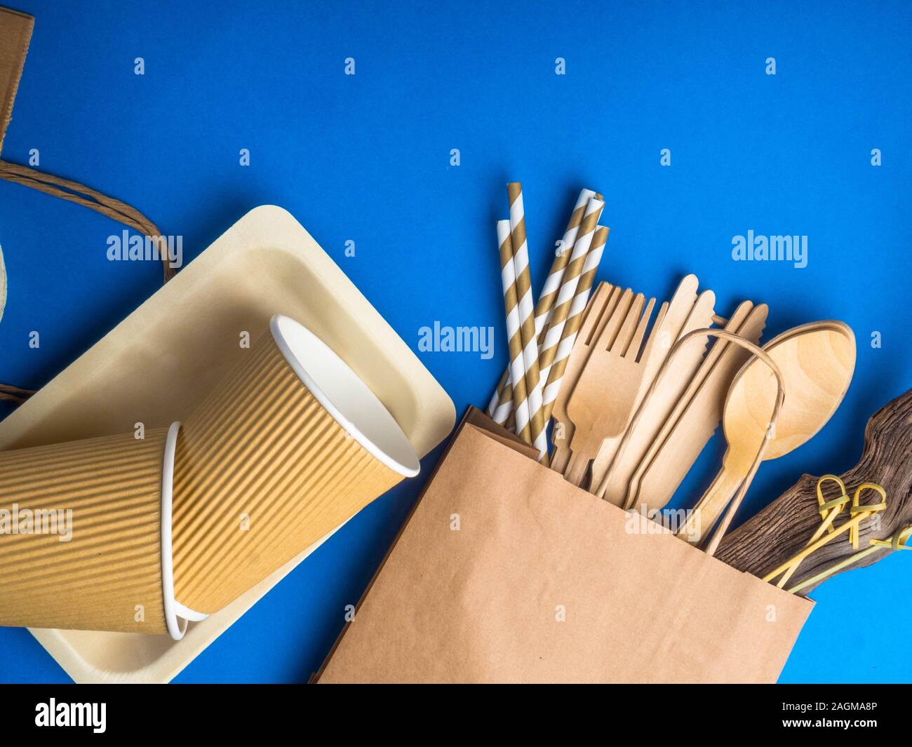 Eco friendly bamboo cutlery set on blue background. Various kraft paper ...