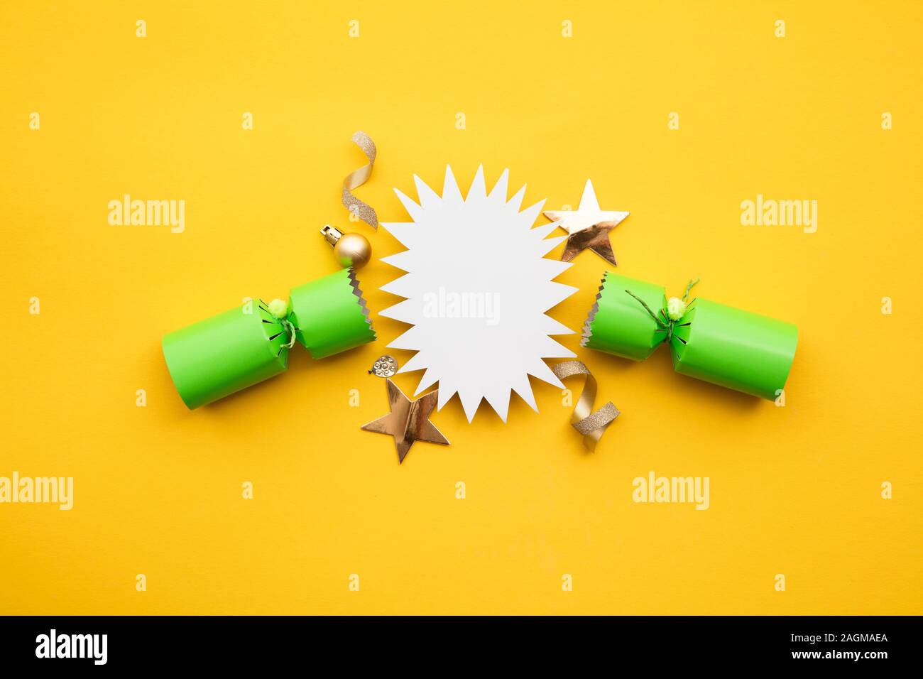Popped Christmas crackers on a yellow background Stock Photo - Alamy