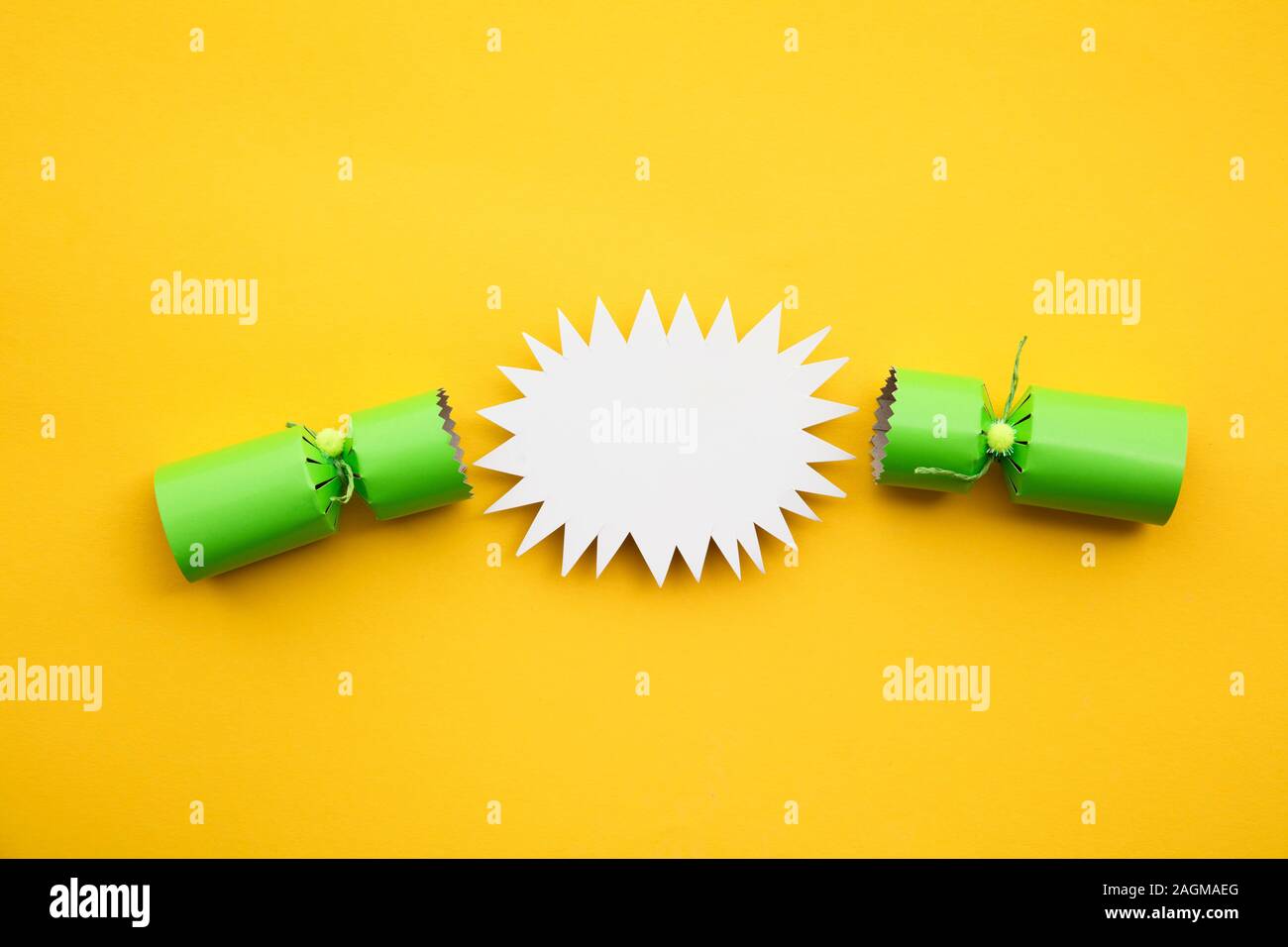 Popped Christmas crackers on a yellow background Stock Photo - Alamy