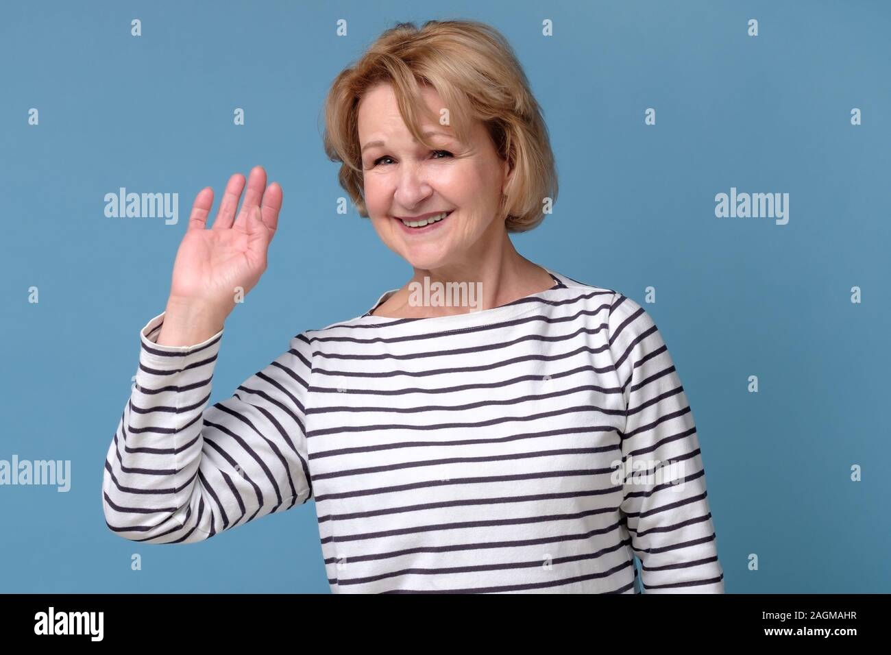 Mature woman waving goodbye hi-res stock photography and images - Alamy