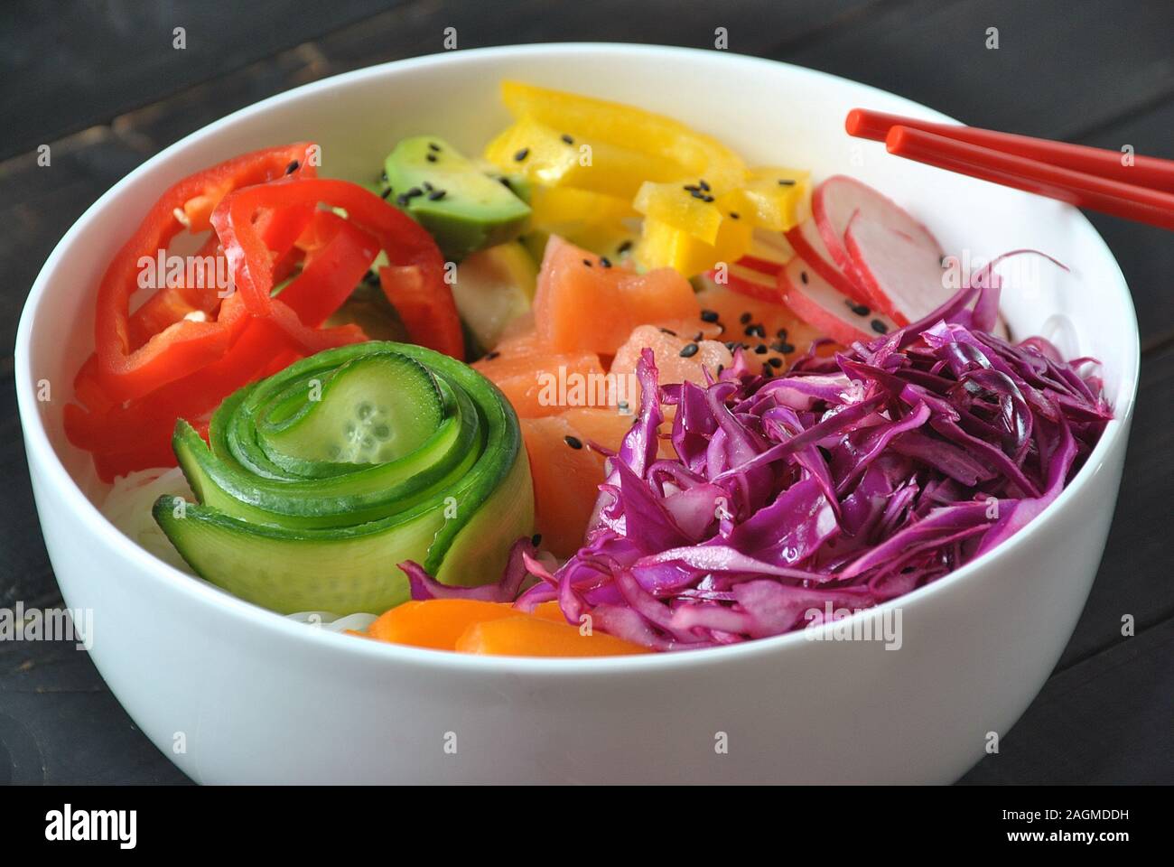 Poke bowls with fresh salmon, crystal noodles, radish, avocado, sweet ...