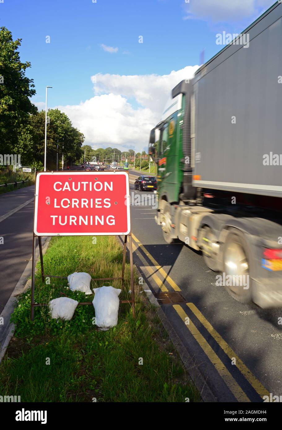 lorry passing warning sign of lorries turning by entrance to building ...