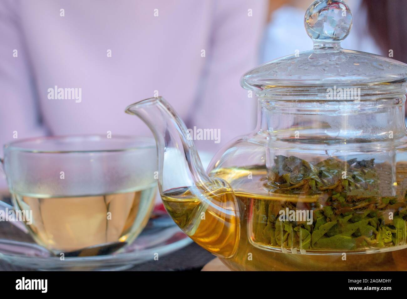 green tea in a teapot and a mug Stock Photo - Alamy
