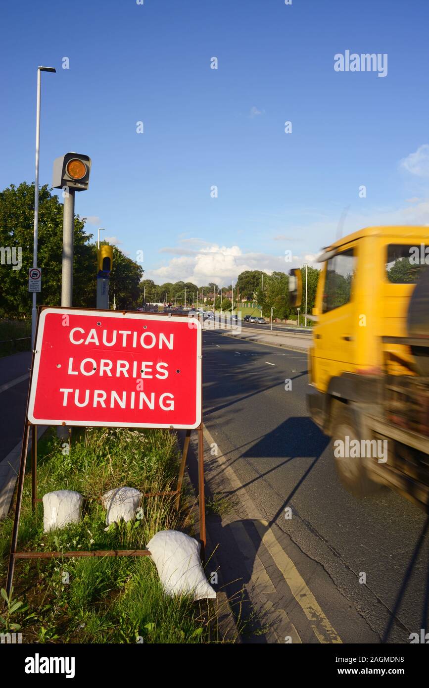 lorry passing warning sign of lorries turning by entrance to building ...