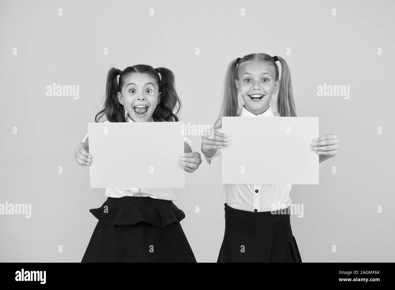 School socialization. Girls school uniform hold poster. Back to school ...
