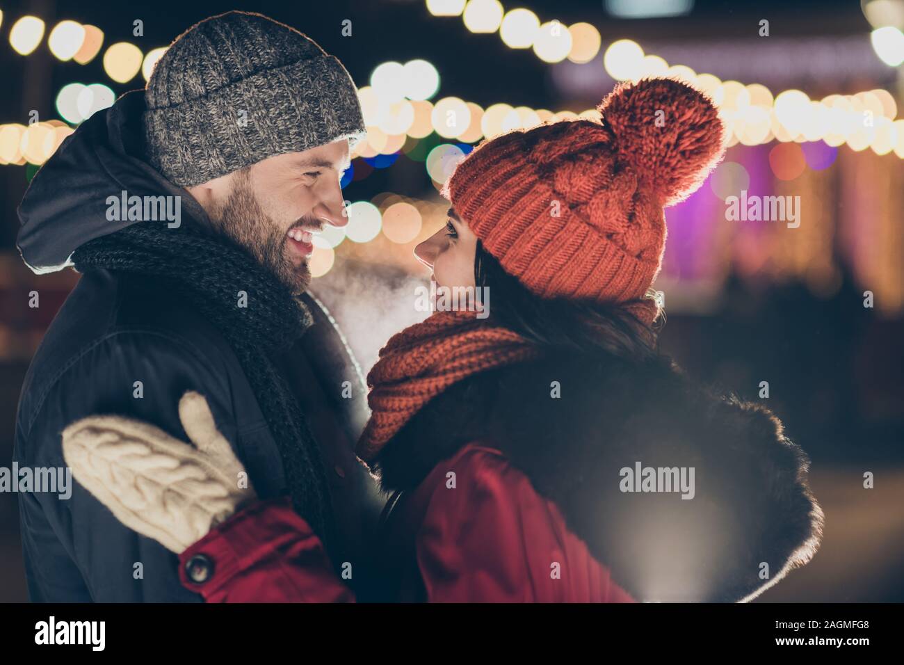 Photo of two amorous pair in love at x-mas midnight illuminated streets ...