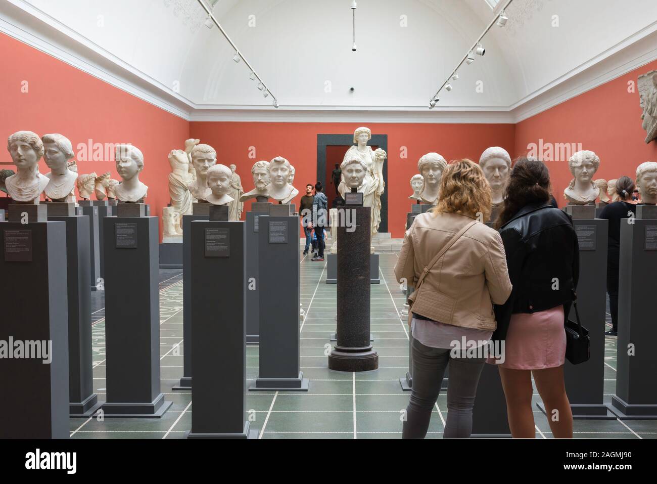 Women museum, rear view of two young women friends looking at ancient ...