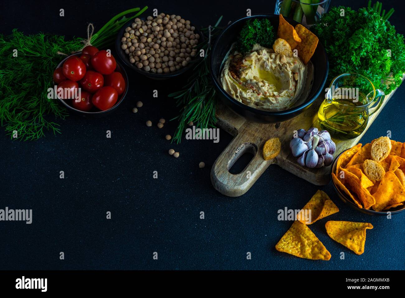 Traditional chickpeas hummus with olive oil and sesame seeds on stone ...