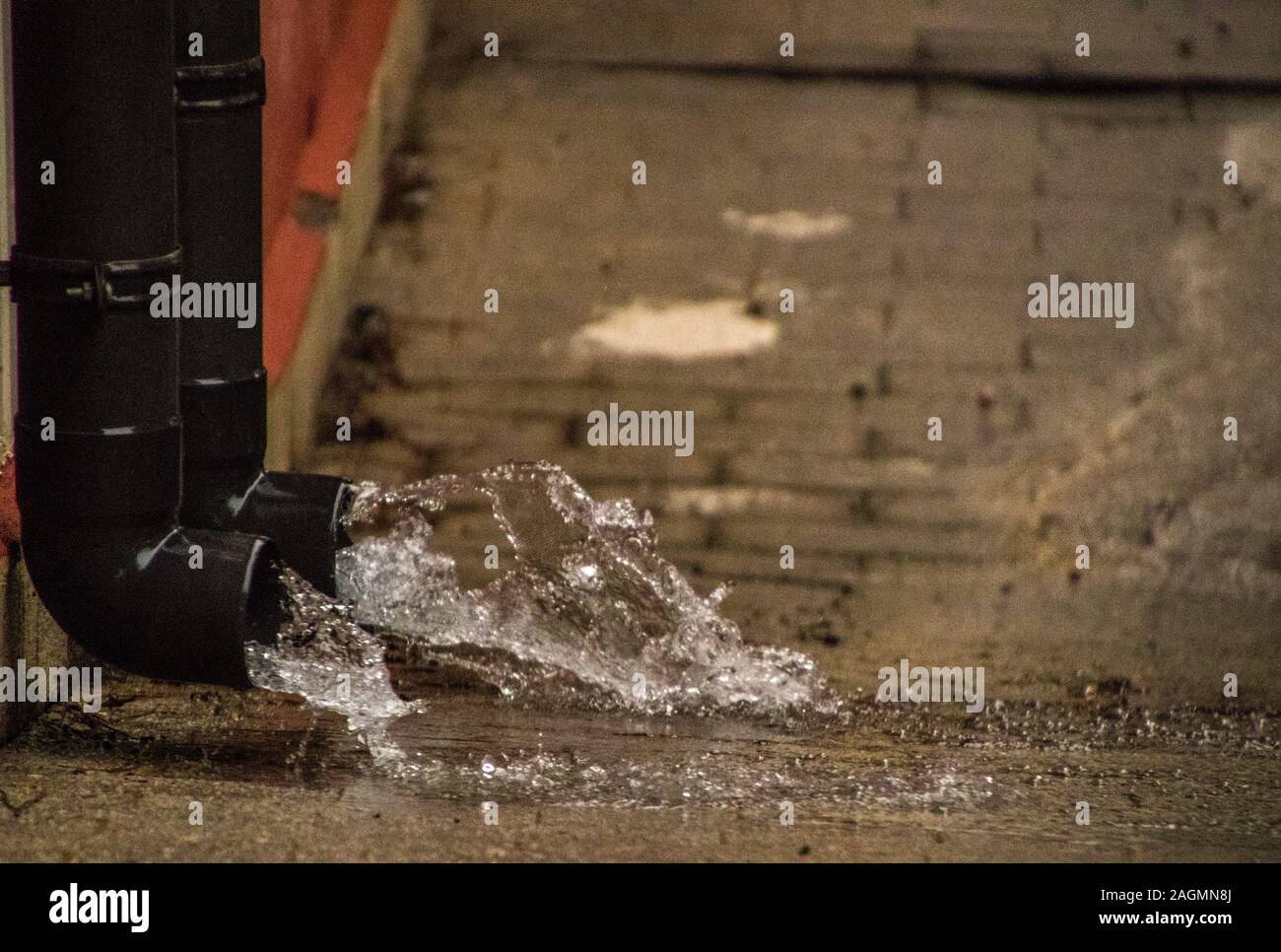 Gutters gush with water from a heavy downpour of rain Stock Photo - Alamy