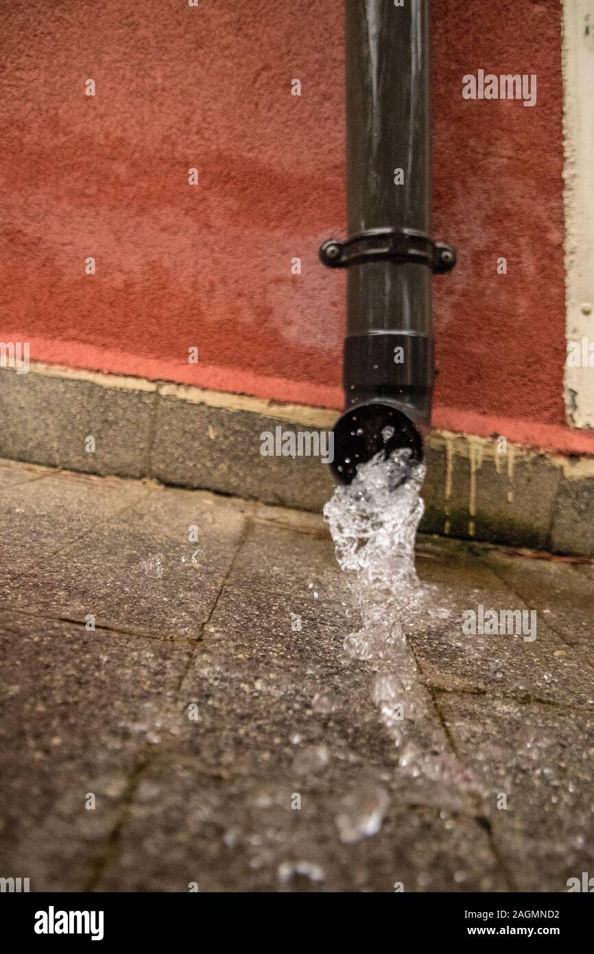 Gutters gush with water from a heavy downpour of rain Stock Photo - Alamy