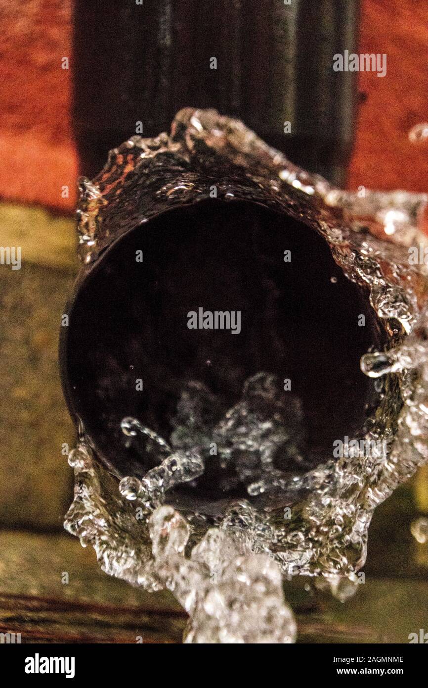 Gutters gush with water from a heavy downpour of rain Stock Photo - Alamy