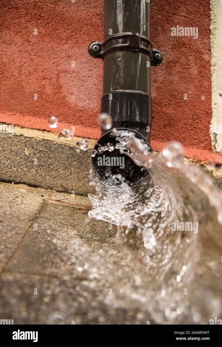 Gutters gush with water from a heavy downpour of rain Stock Photo - Alamy